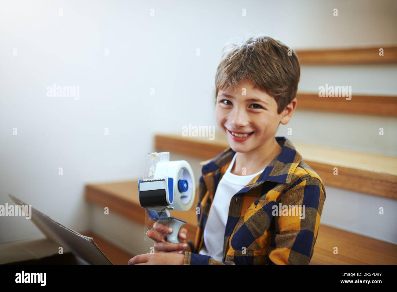 Im ready to help pack today. an adorable little boy packing boxes on ...