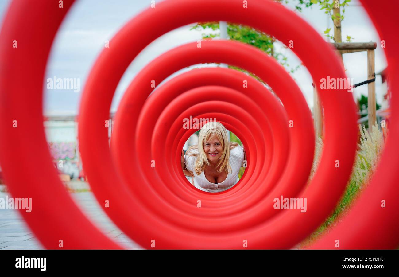 portrait of a happy old woman inside a red spiral. frame perspective ...