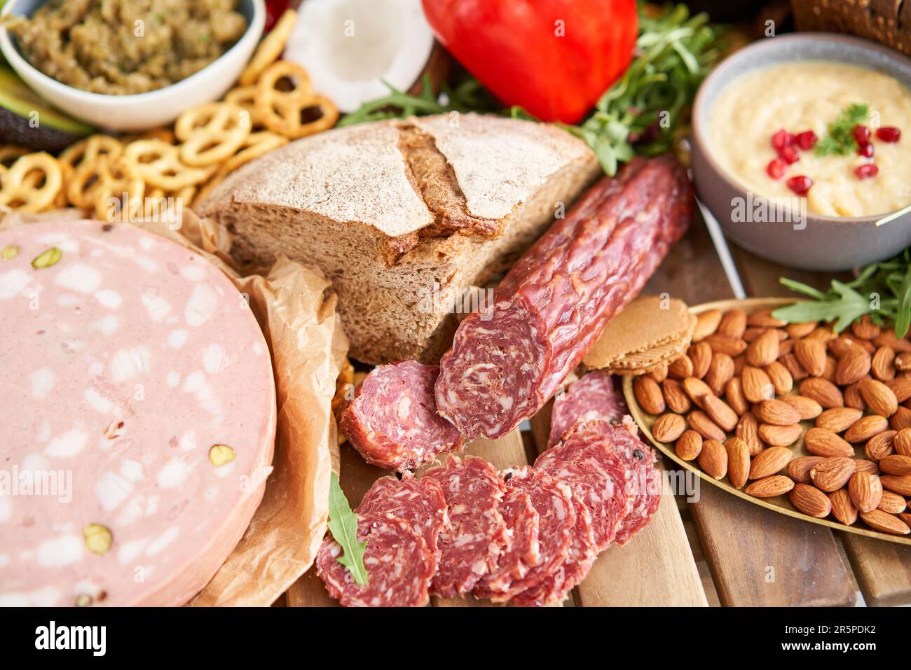 Salami sausage close-up. Table full of mediterranean appetizers, tapas ...