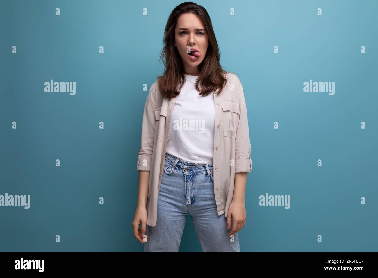 cute 25 year old female person in casual look posing on blue background ...