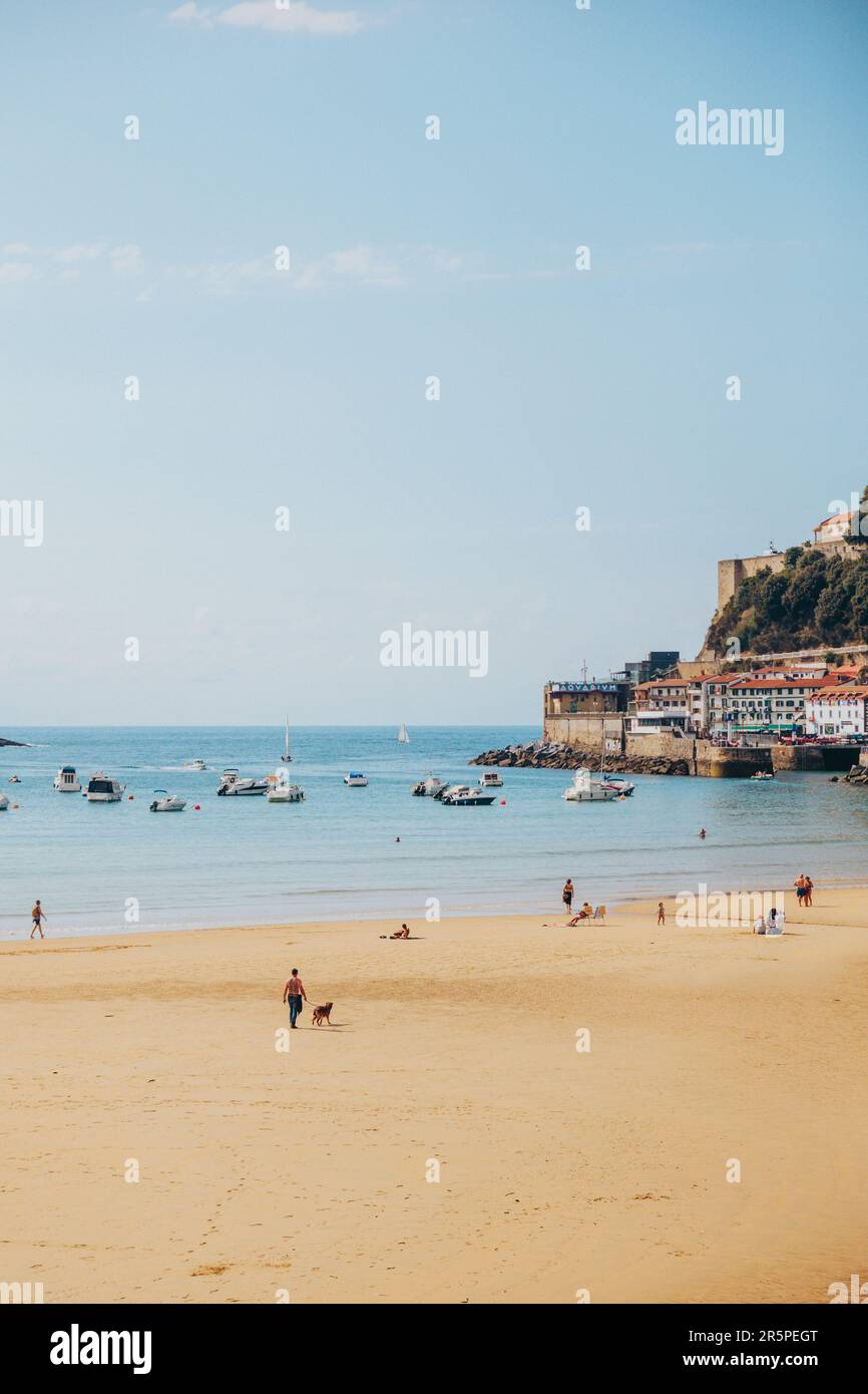 Crowd of people enjoying summer holiday on sandy La Concha beach ...