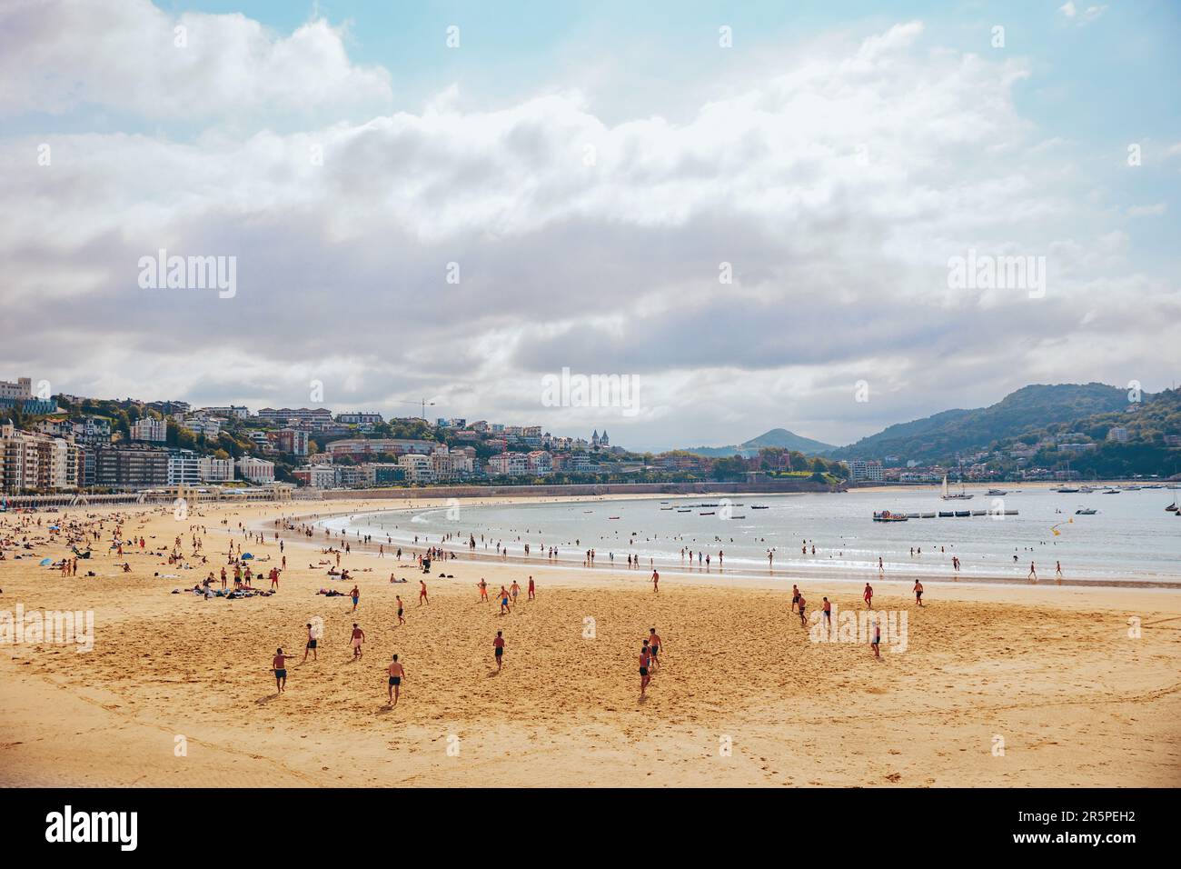 Crowd of people enjoying summer holiday on sandy La Concha beach ...