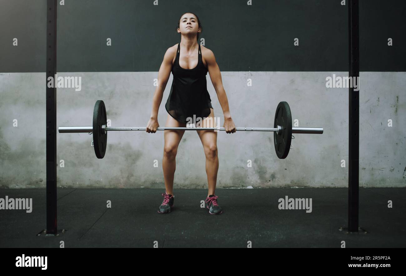 Strong, weight lifting and woman with barbell in gym for training ...