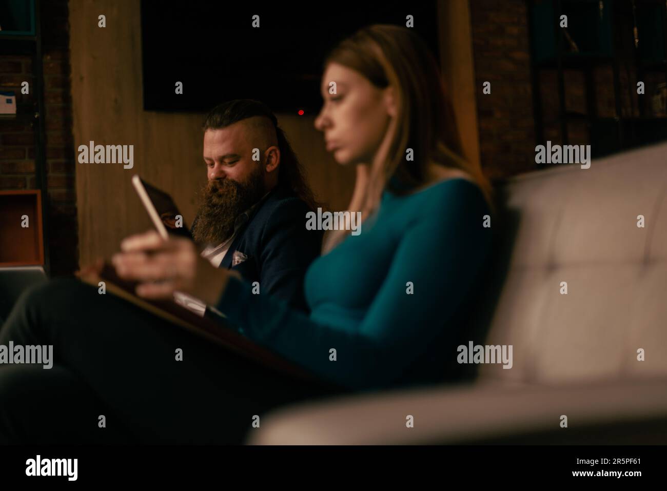 A close up shot of two business coworkers, male and female, working on ...