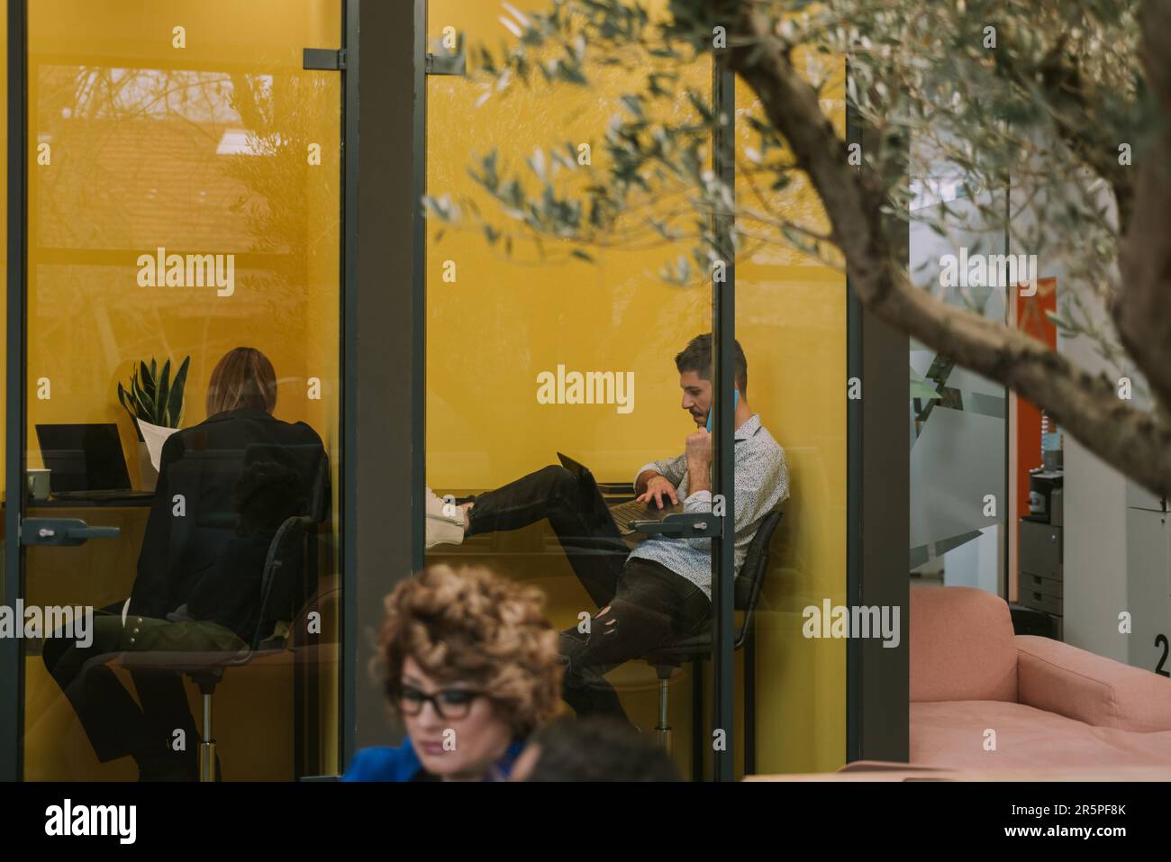 Male and female colleagues working on their daily tasks while having ...