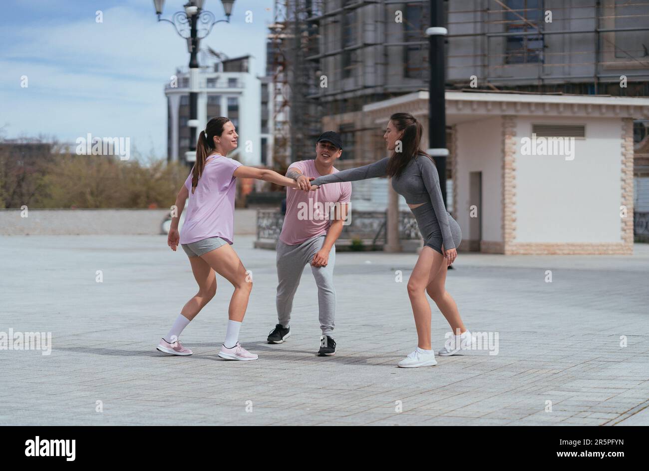 Beautiful, fit sportspeople putting their hands together after ...