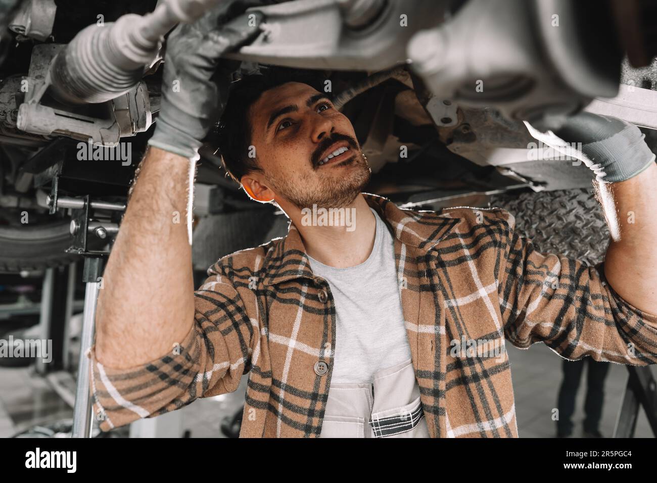 Auto mechanic checking running gear hi-res stock photography and images ...