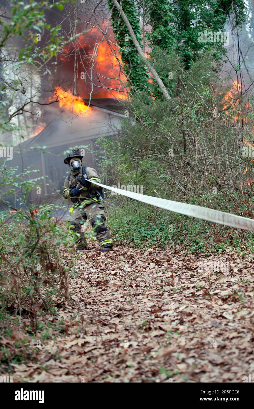 Firefighters extinguishing house fire Stock Photo - Alamy