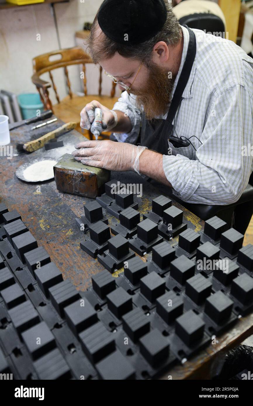 An orthodox Jewish craftsman prepares tefillin boxes to be led with the ...