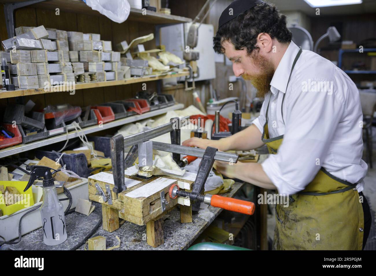 A rabbi and master craftsman makes tefillin in the ancient traditional ...