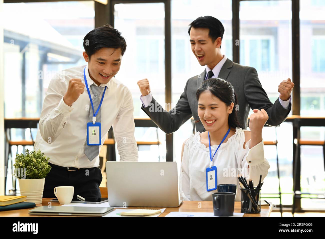 Happy employees team celebrating at the meeting room. Business ...