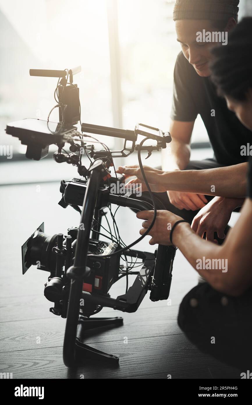 Pay attention to detail. Behind the scenes shot of two young camera ...