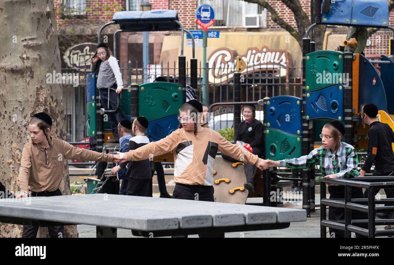 A group of orthodox Jewish yeshiva students play in Sobel Playground ...