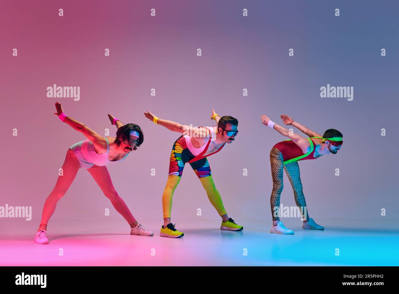 Flexible men in colorful, funny sportswear training, doing stretching ...