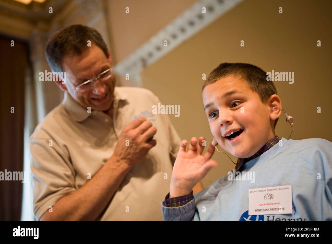 A Romanian boy hears for the first time after being fit with hearing ...