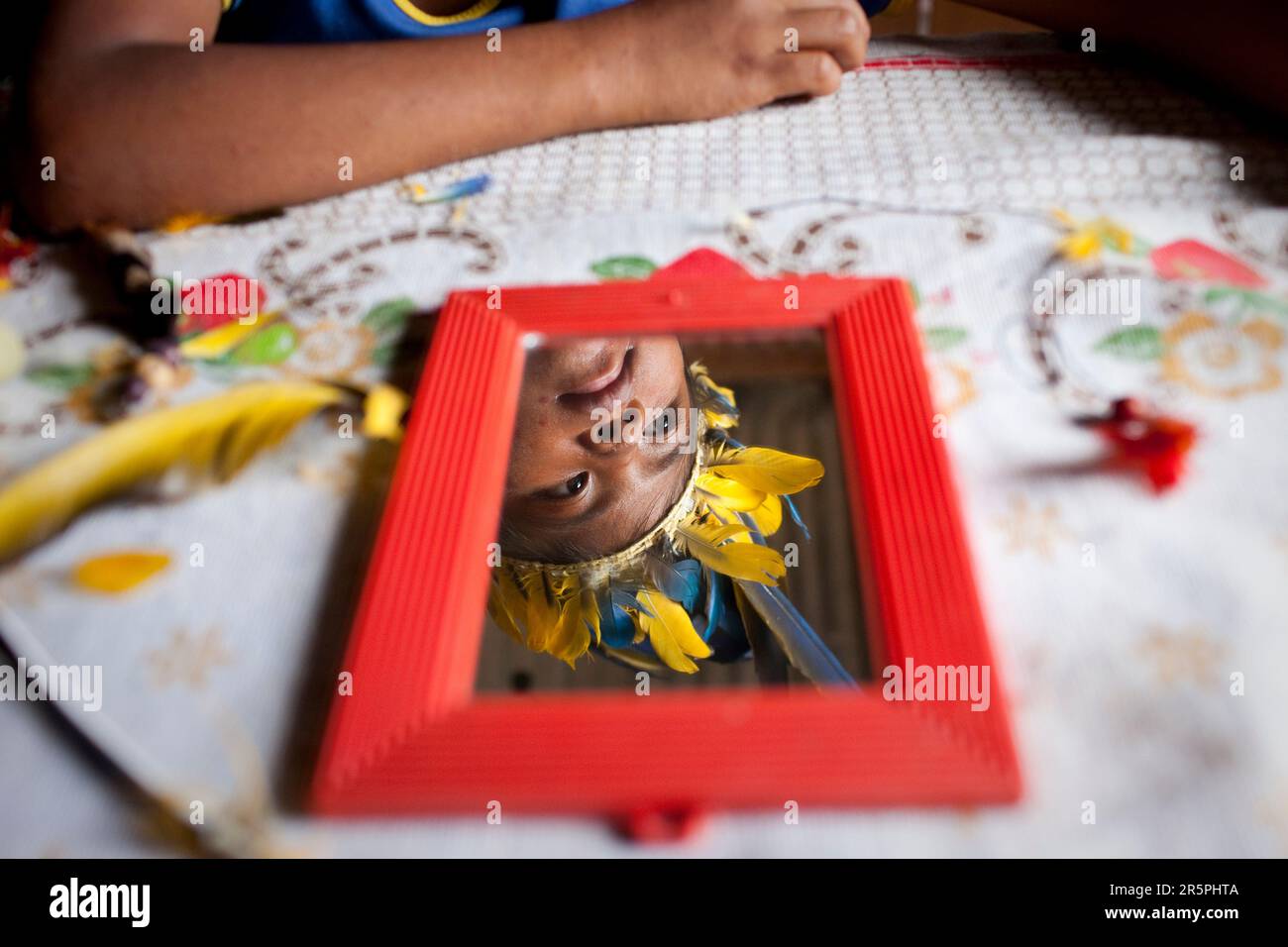 An Oro Win girl wears a head dress as she prepares for a traditional ...