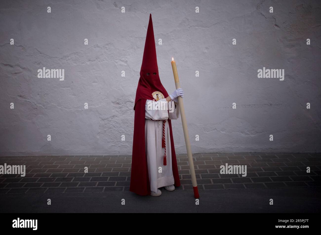 Penitents walk in a street during easter Holy Week celebrations in ...