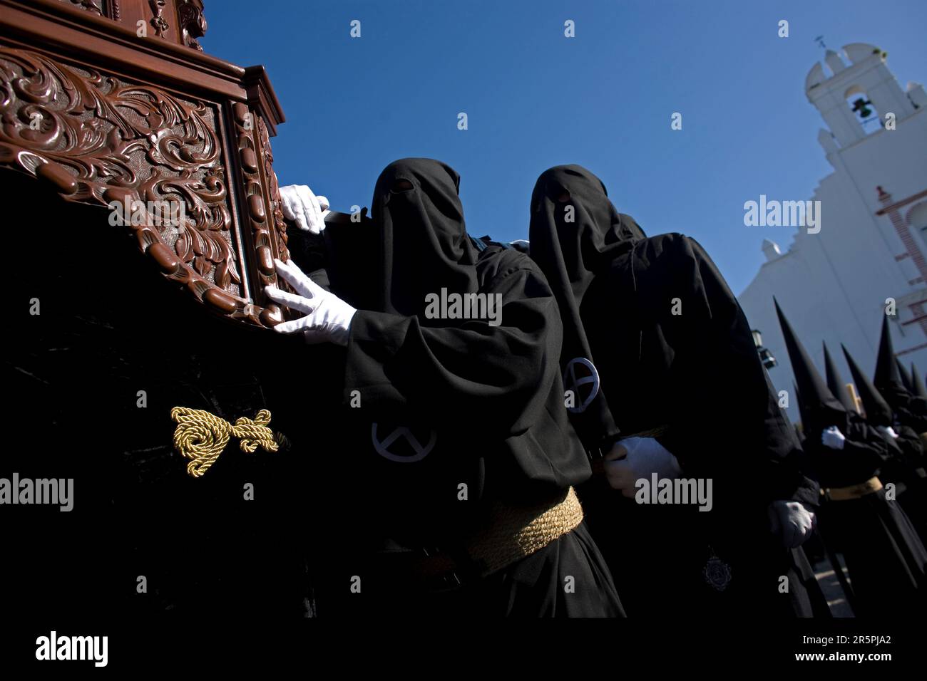 Penitents carry a throne during a procession for easter Holy Week ...