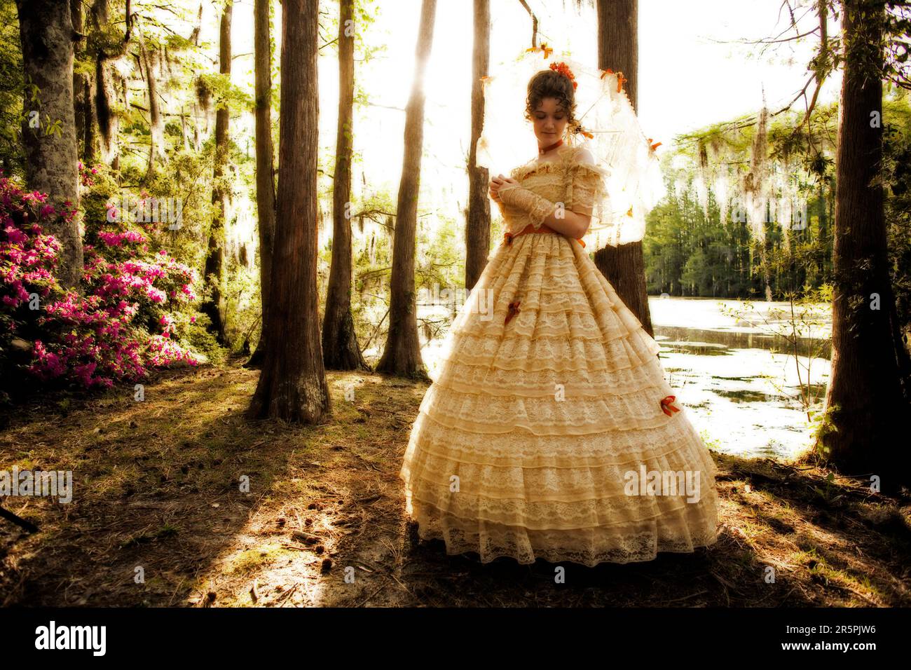 A young woman poses in a Southern Belle outfit , including a large, ornate period-dress and ...