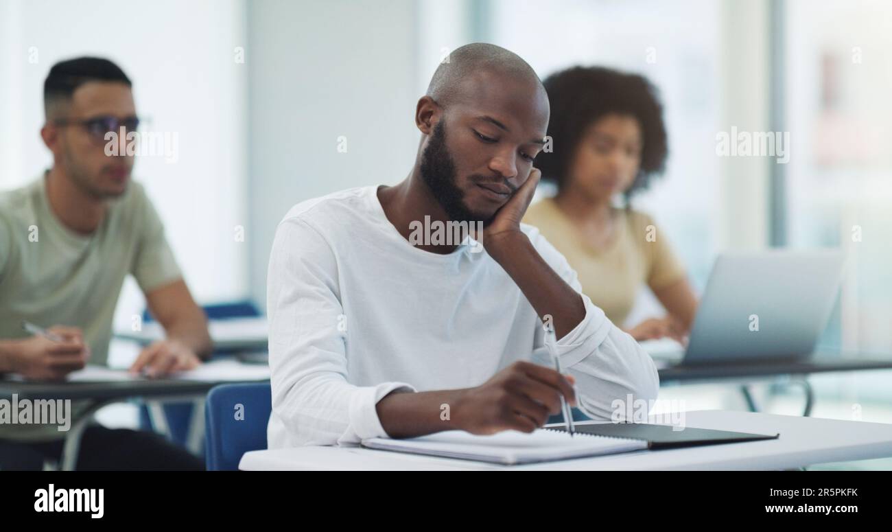 Black man, student desk and bored in university class with learning for ...