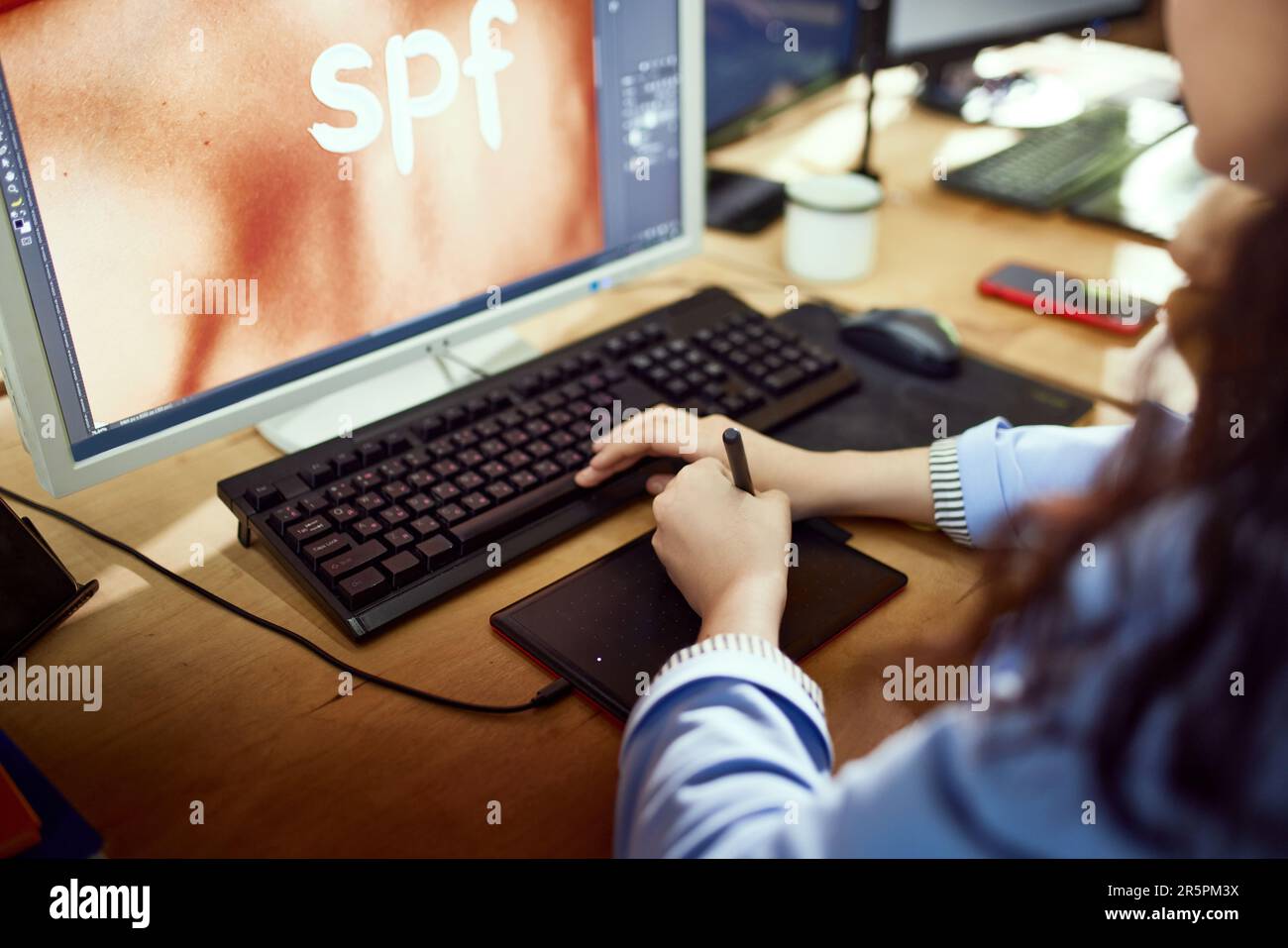 Close-up image of female hands, graphic designer, retoucher working ...