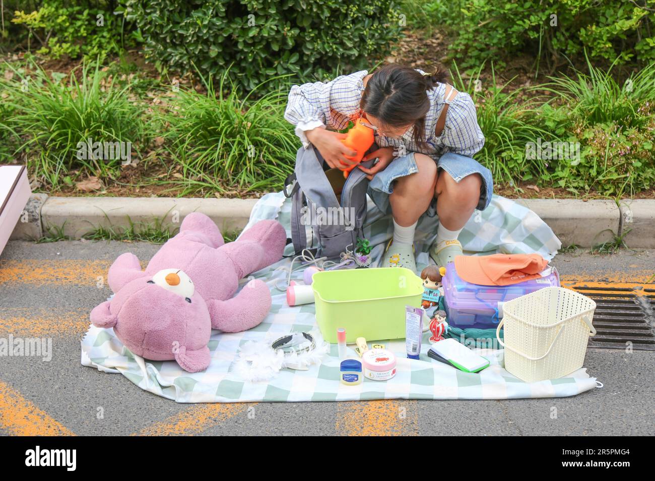Students select various goods at the flea market at Henan University of ...
