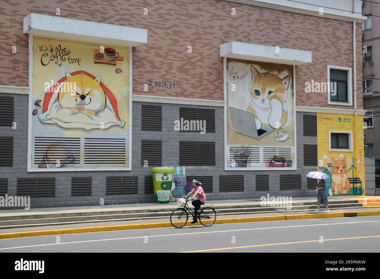 Dog murals on the walls on Wuding Road and Yanping Road draw people in ...