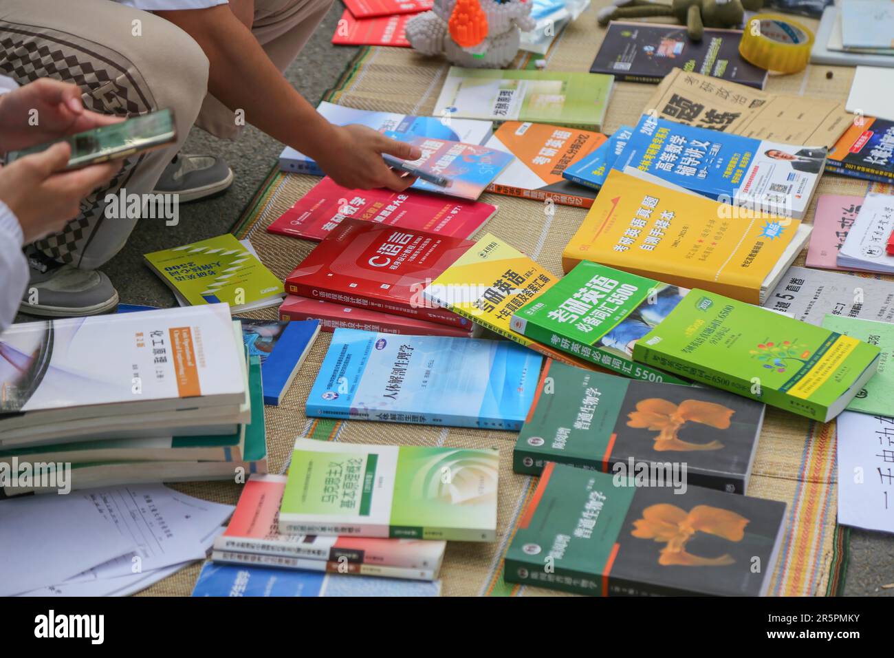 Students select various goods at the flea market at Henan University of ...