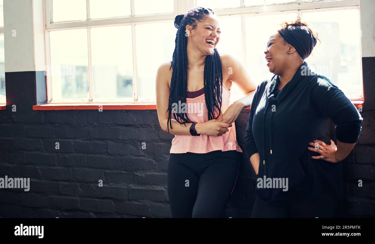 Fitness friends. two cheerful young women having a conversation before ...