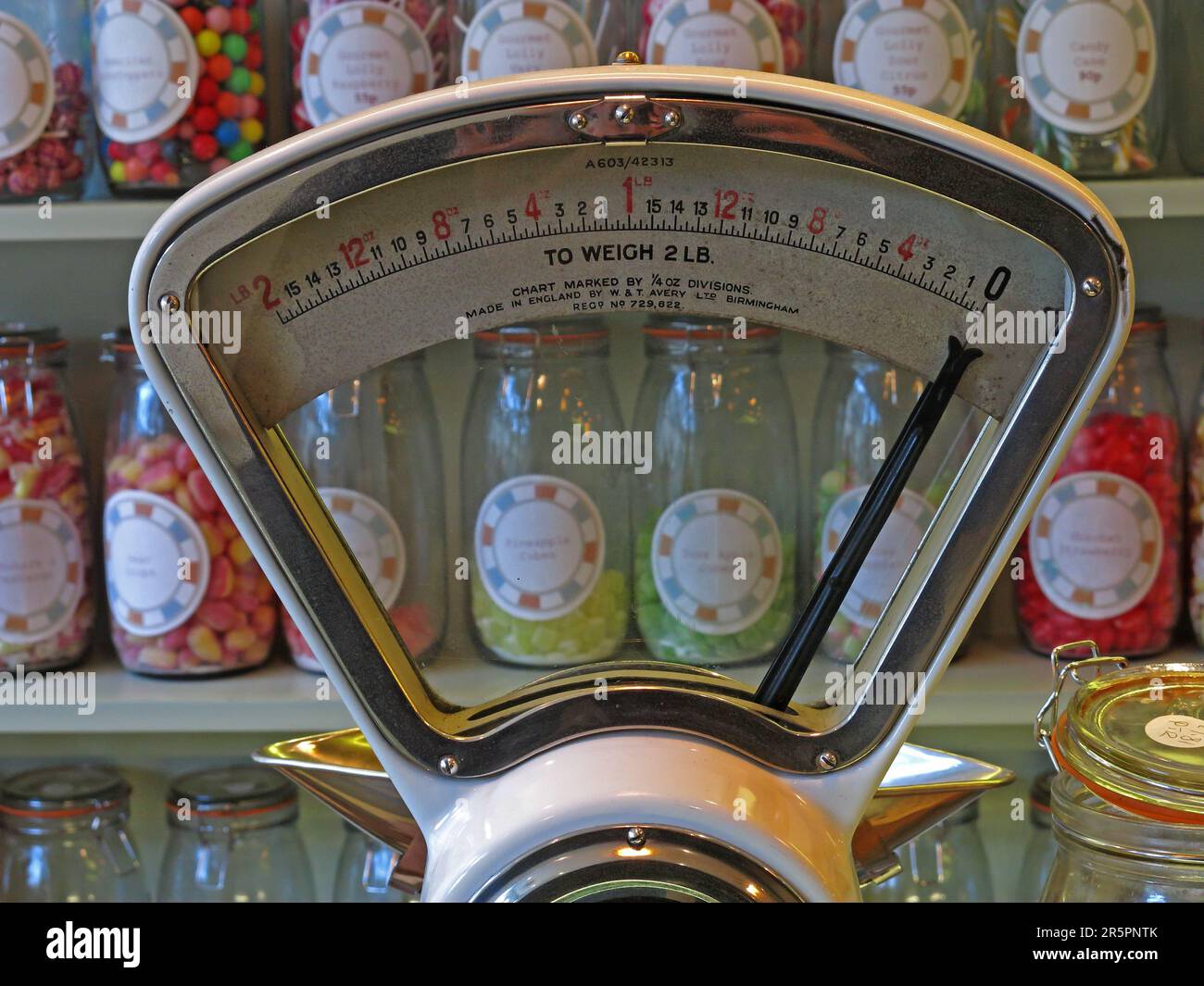 Traditional sweet shop weighing scales in front of shelves filled with ...