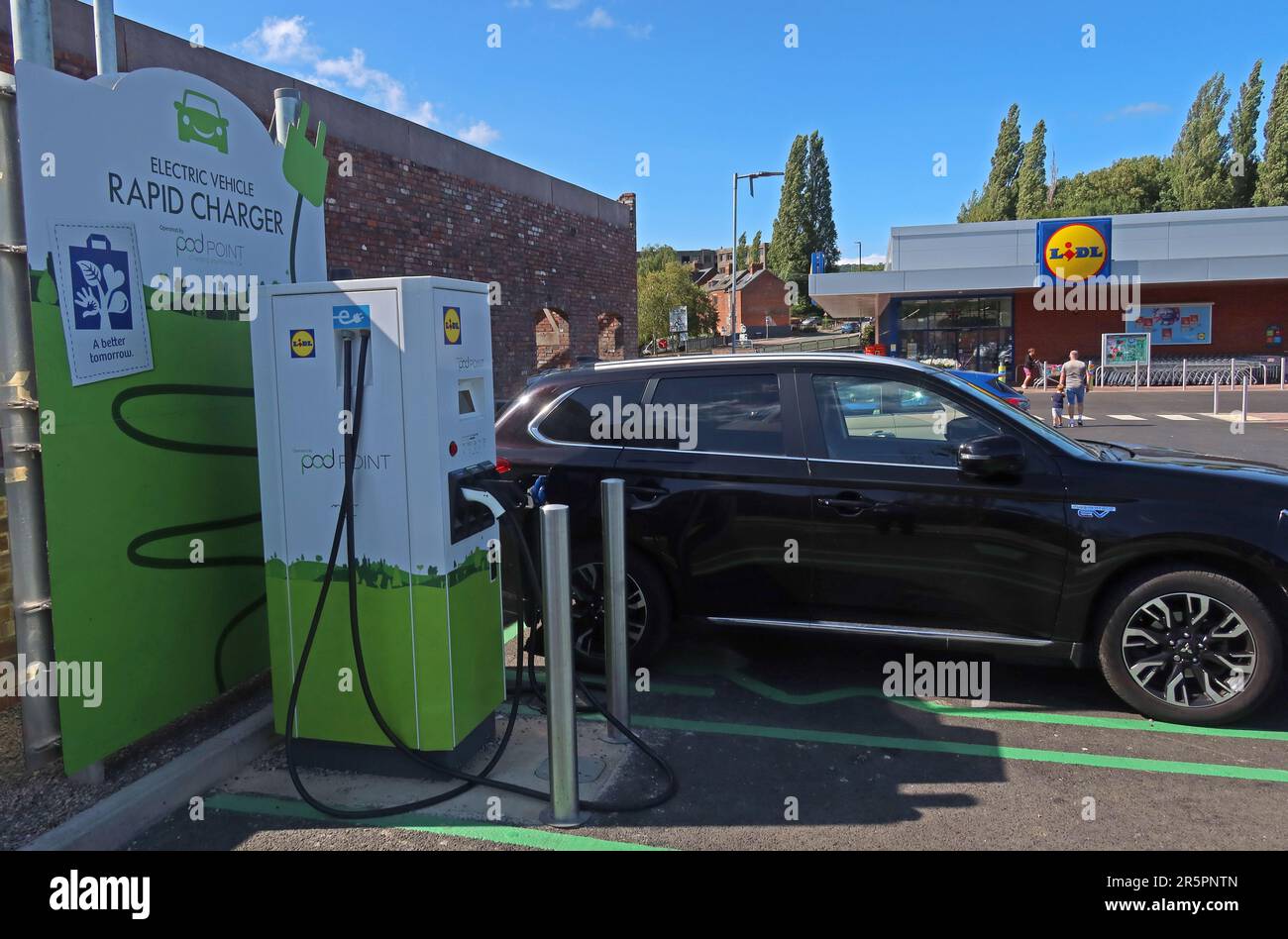 Plug-in hybrid car charging at a Pod Point electric vehicle rapid ...