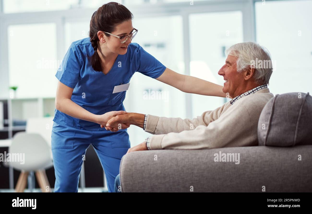 Hey Let me help you. a young female nurse helping her senior patient up ...