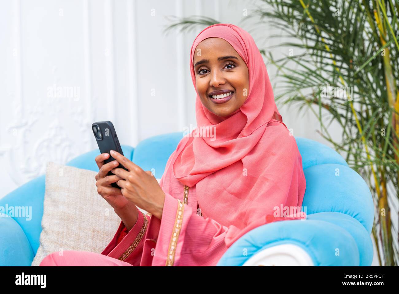 Happy middle-eastern woman wearing abaya at home - Beautiful muslim ...