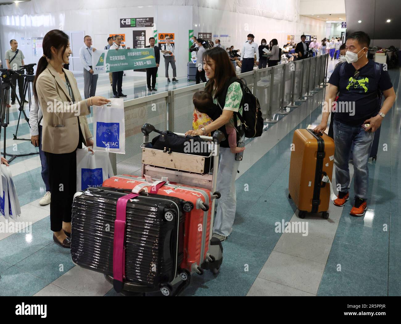 Passengers of the first flight operated by Spring Airlines Co., Ltd ...