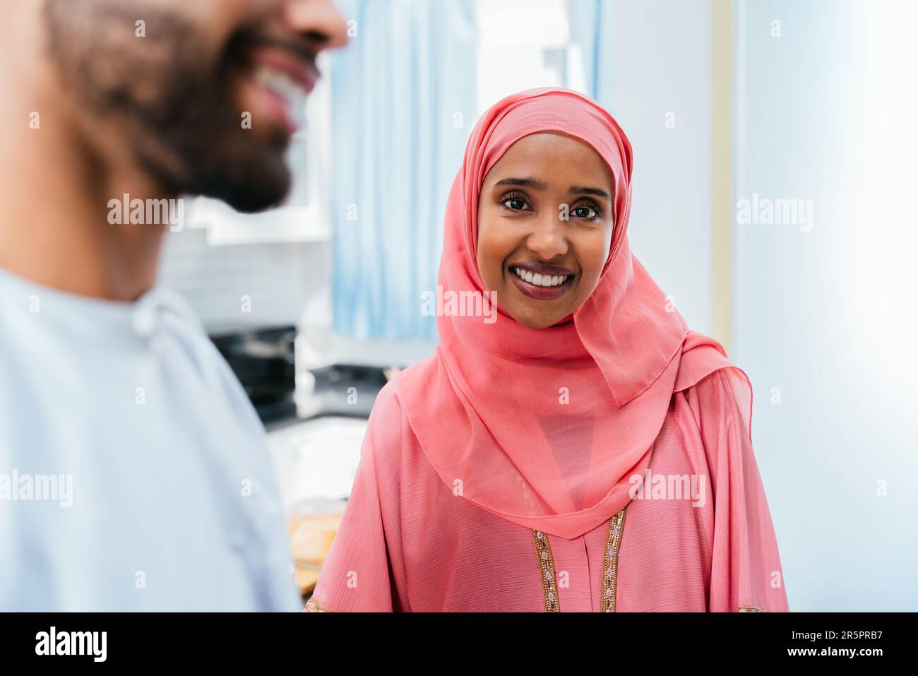 Happy middle-eastern couple wearing traditional arab clothing at home ...