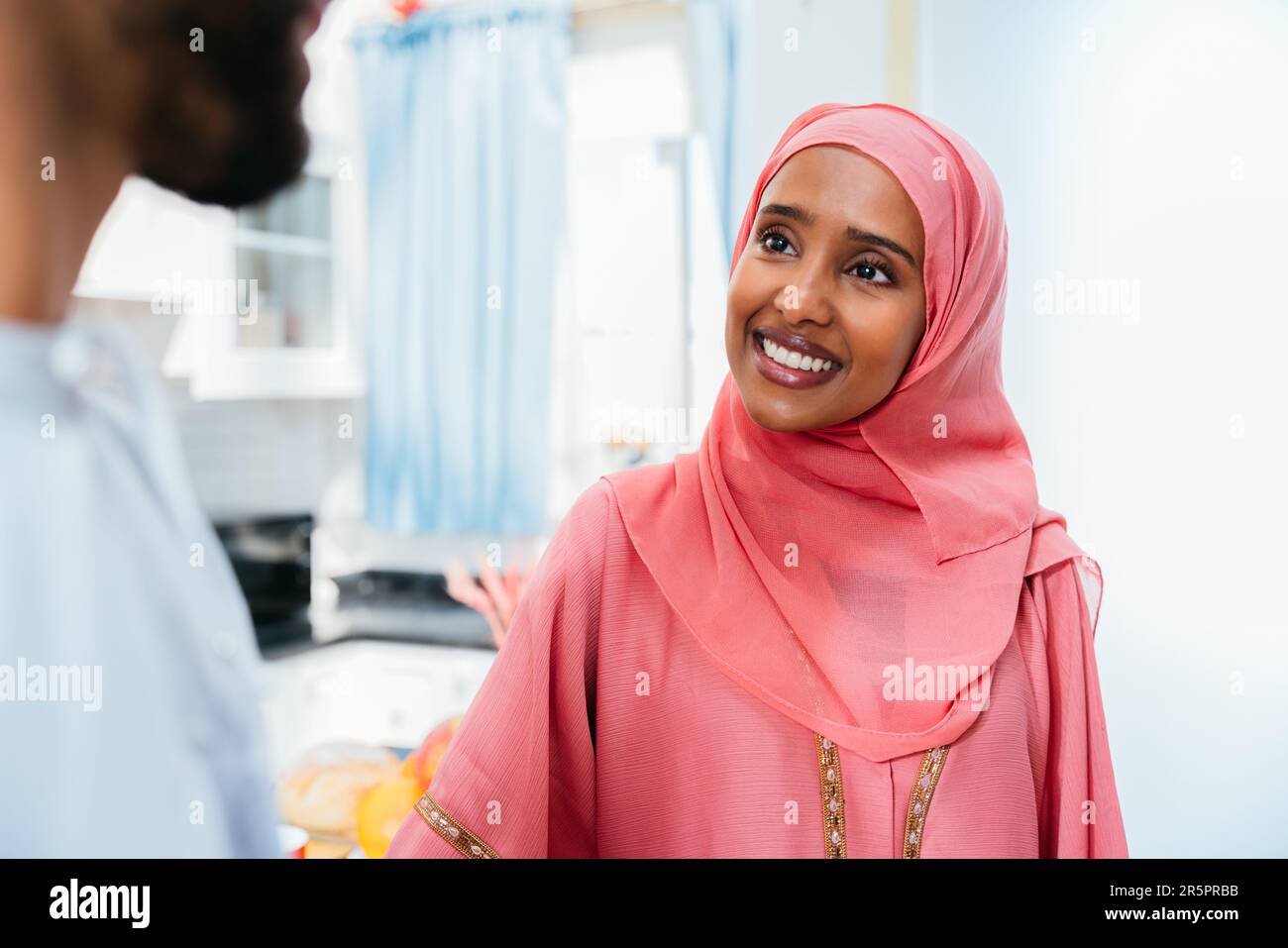 Happy middle-eastern couple wearing traditional arab clothing at home ...