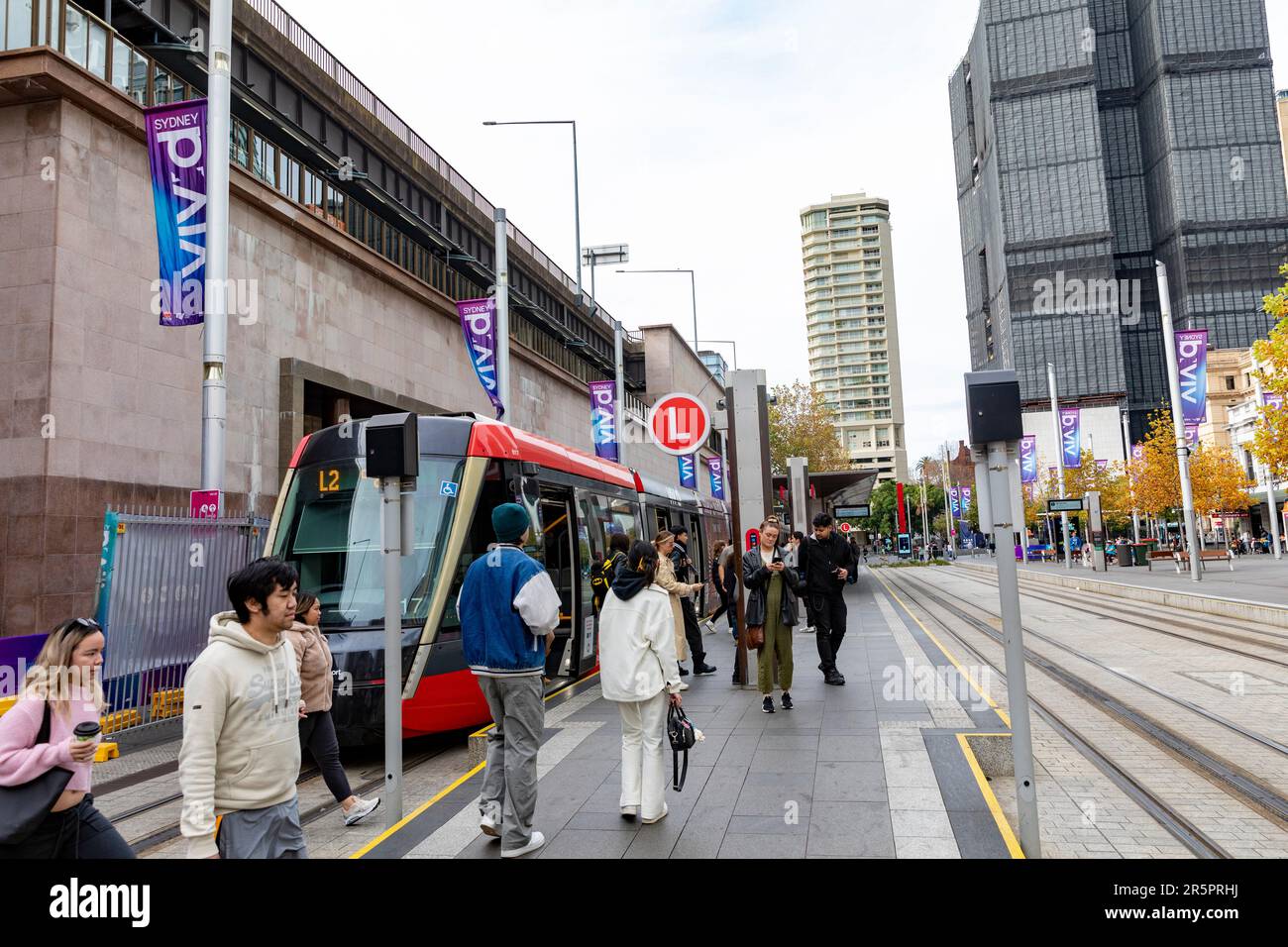 Sydney light rail train and passengers commuters at Circular Quay ...