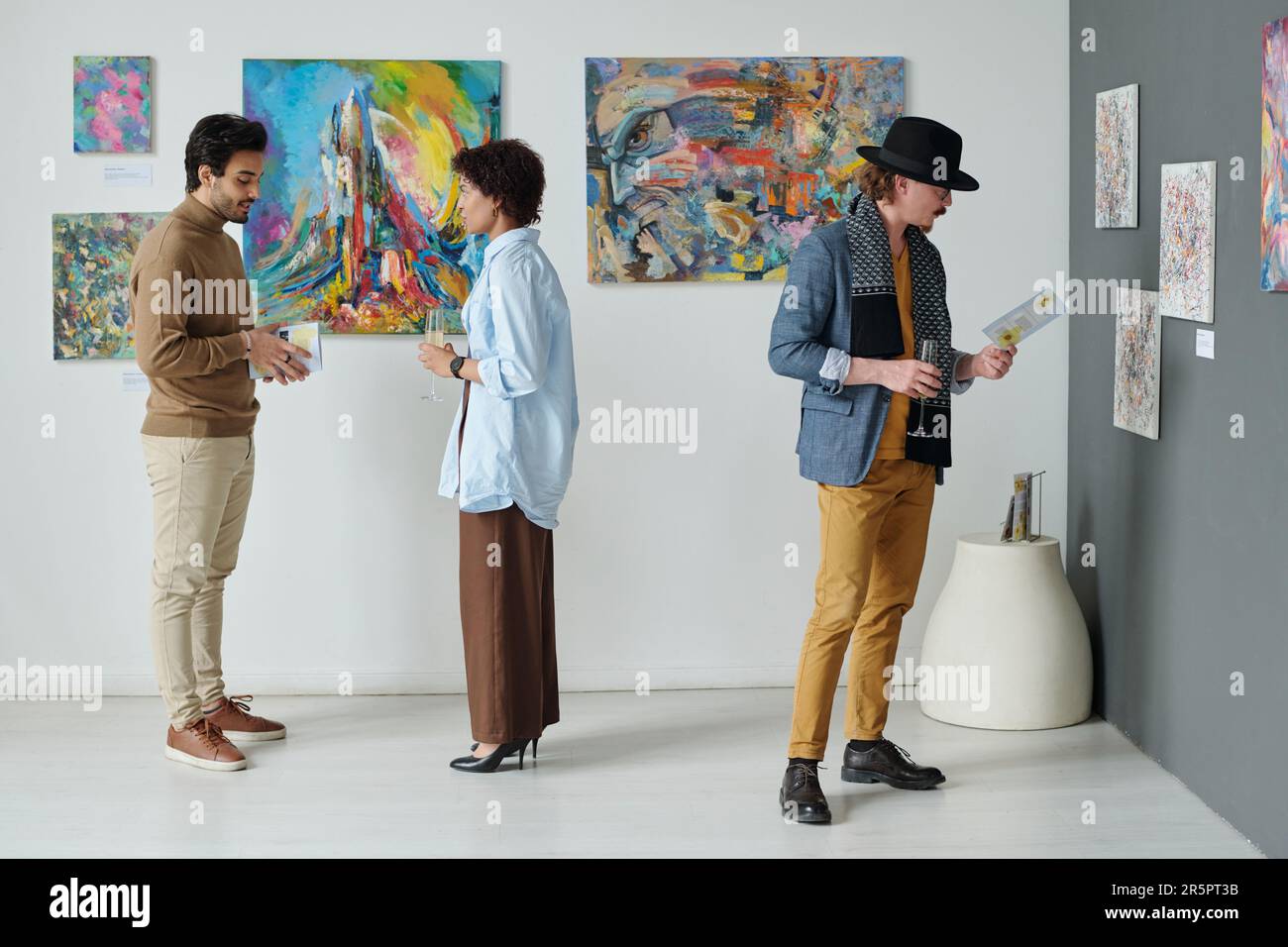 Group of people visiting the exhibition of modern art, they enjoying ...