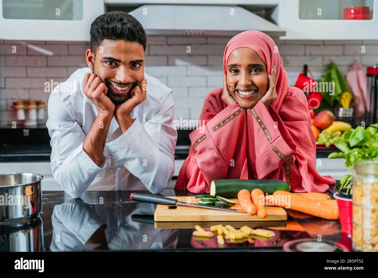 Happy middle-eastern couple wearing traditional arab clothing at home ...