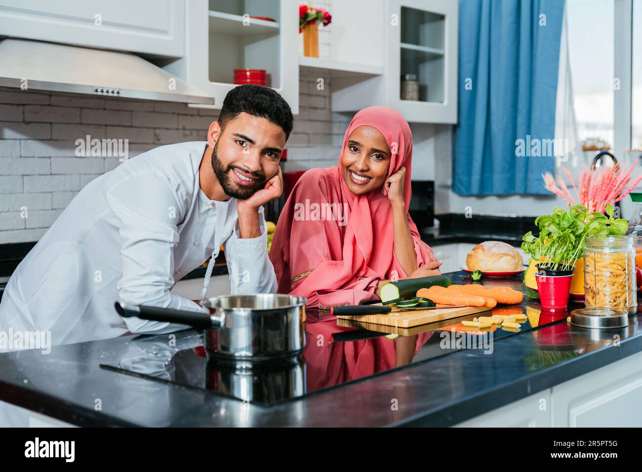 Happy middle-eastern couple wearing traditional arab clothing at home ...