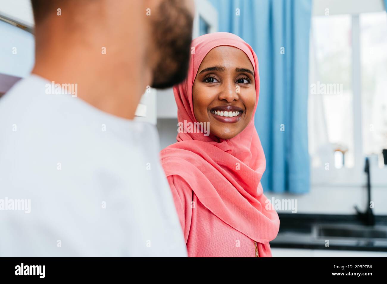 Happy middle-eastern couple wearing traditional arab clothing at home ...