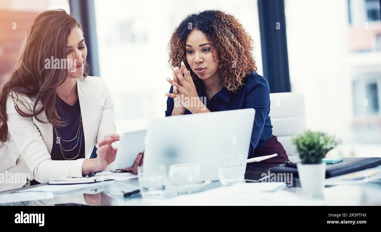 Their tool of choice for team tasks. two businesswomen using a digital ...