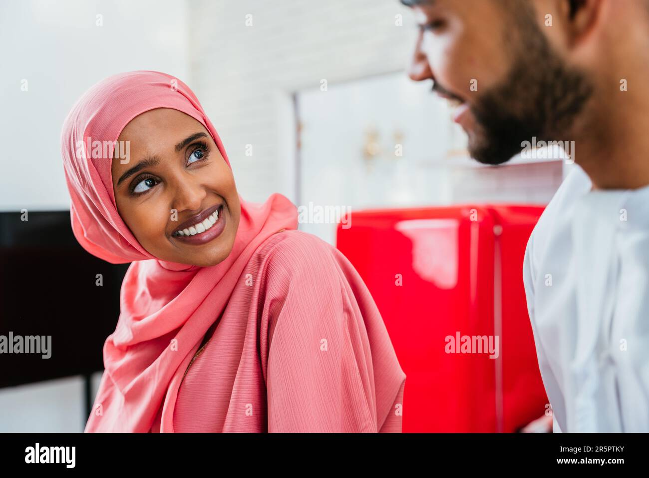 Happy middle-eastern couple wearing traditional arab clothing at home ...