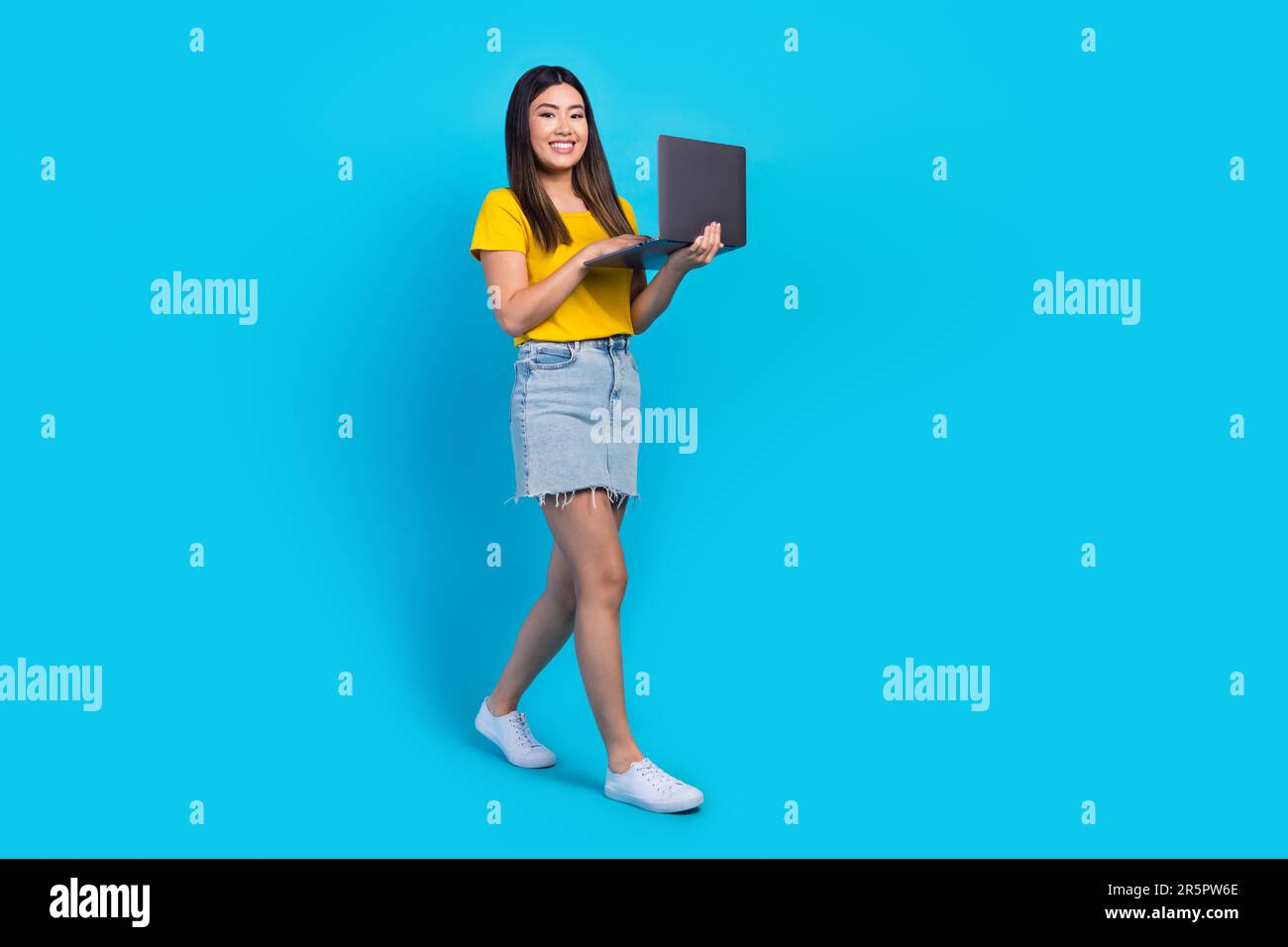 Full length profile photo of attractive person walking hold use netbook ...