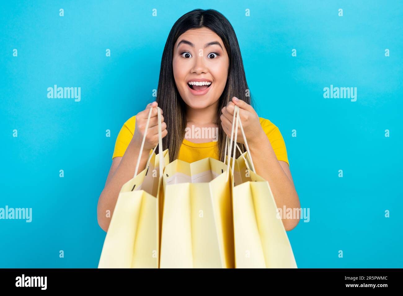 Portrait of ecstatic woman dyed hairstyle wear stylish t-shirt holding ...
