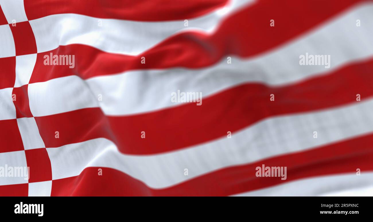 The civil flag of Bremen waving in the wind. Eight red and white ...