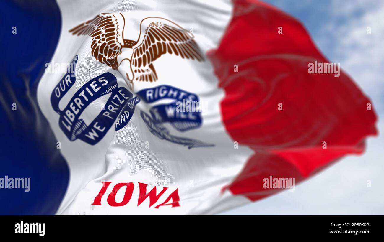 Close-up of the Iowa state flag waving. Three vertical stripes of blue ...