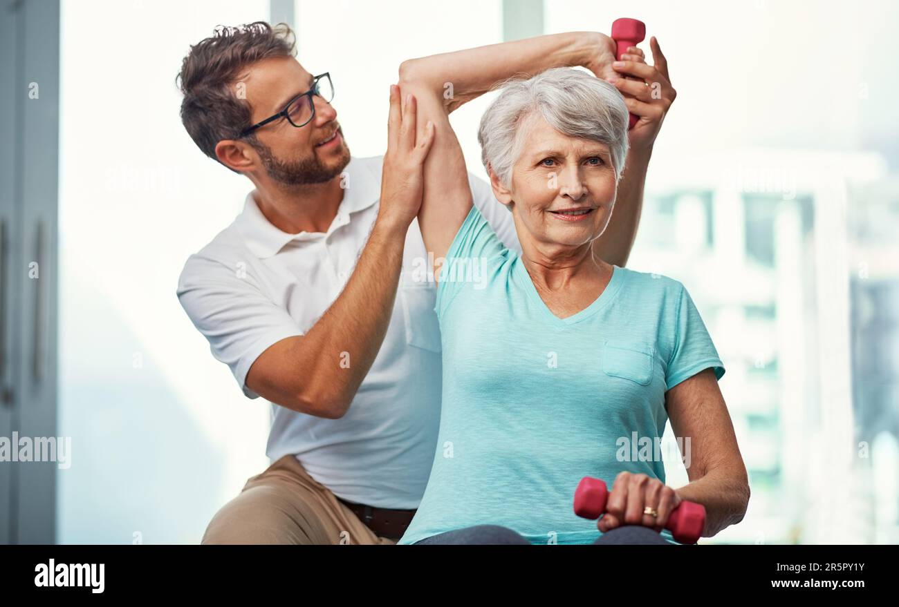 Staying healthy as she ages. a senior woman working through her ...