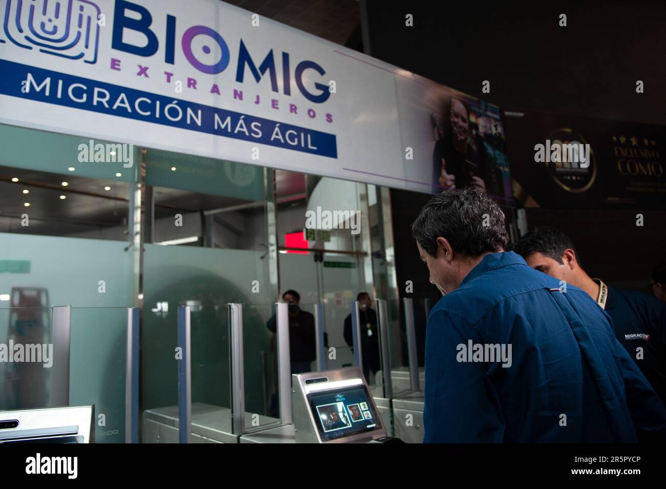 Passangers use the new biometric migration system during the launch of ...