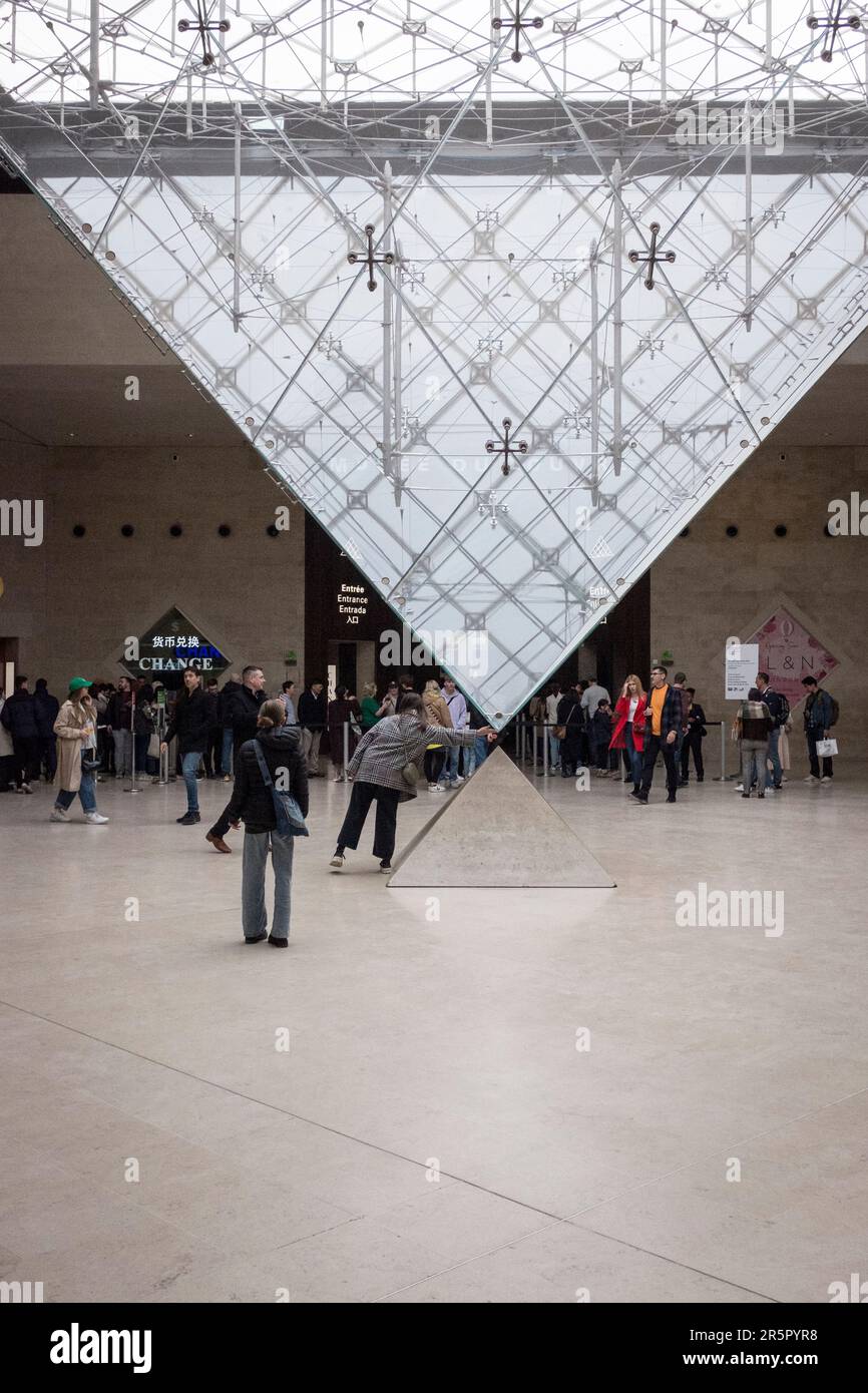 People in Paris, France gather around the captivating inverted pyramid ...